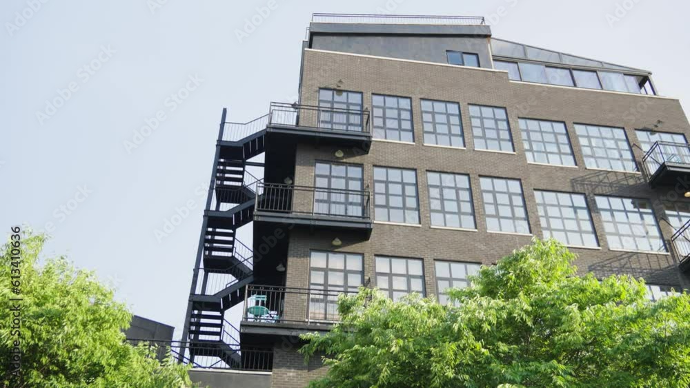 Warehouse lofts of brown brick, renovated with large bay windows and ...