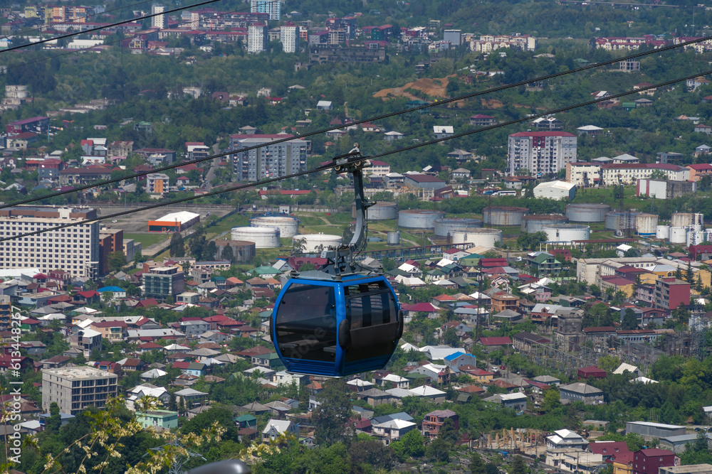 Close-up of an empty cab on a cable car over the city and mountains ...