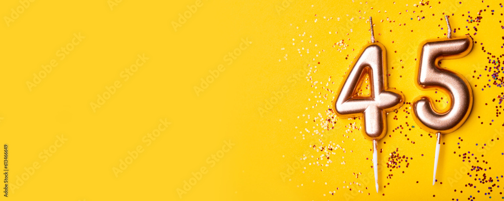 45 years celebration. Greeting banner. Gold candles in the form of ...