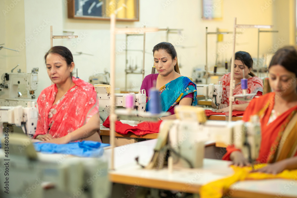 Indian women group working on sewing machine at textile factory. Stock ...
