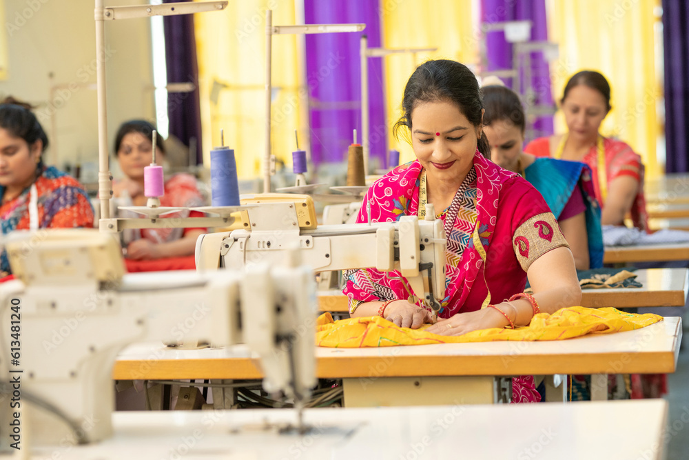 Indian women group working on sewing machine at textile factory. Stock ...