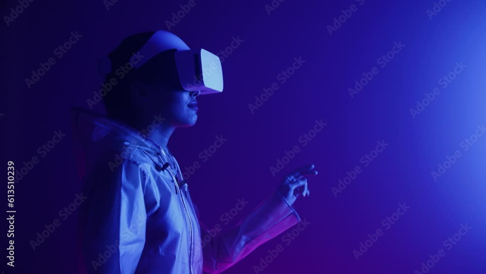 Woman in futuristic costume. Girl in glasses of virtual reality while ...