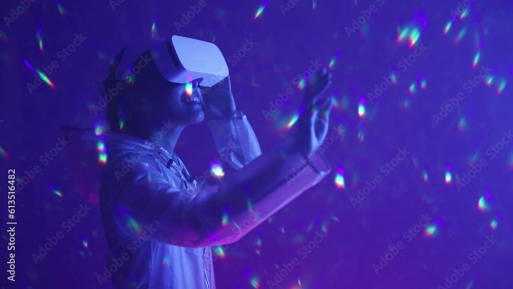 Woman in futuristic costume. Girl in glasses of virtual reality while ...
