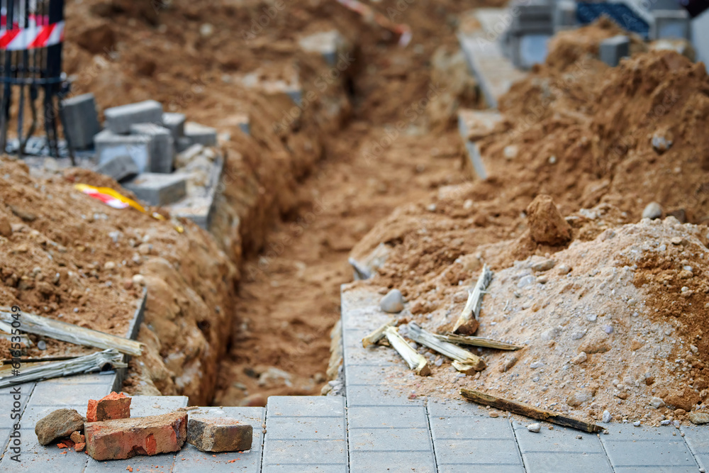 Trench in paved sidewalk. Pipeline repair work. Emergency road ...