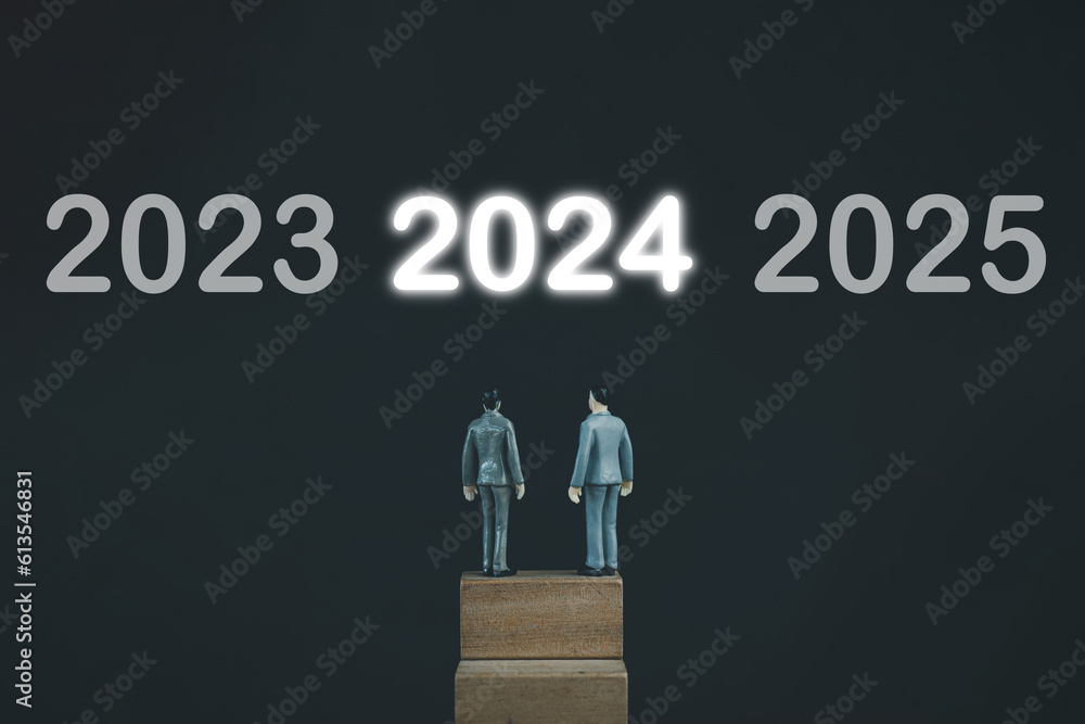 A group of businessman standing in top of high stair and focus on 2024 ...