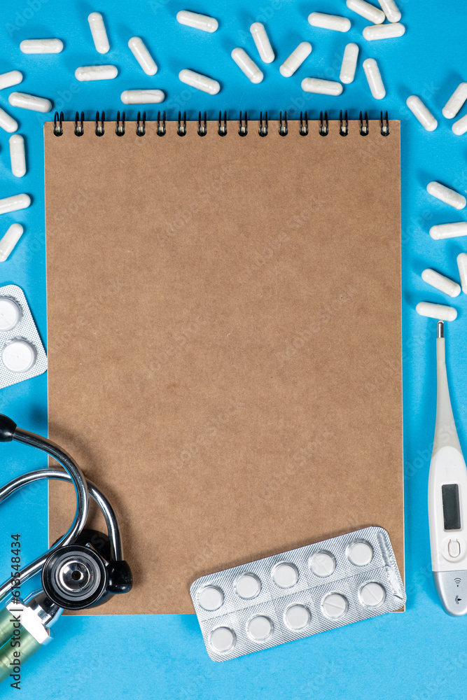 Medical mockup - notepad with stethoscope, pills and thermometer, top ...