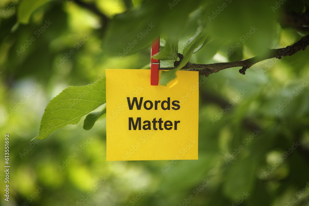 A yellow paper note with the phrase Words Matter on it attached to a ...