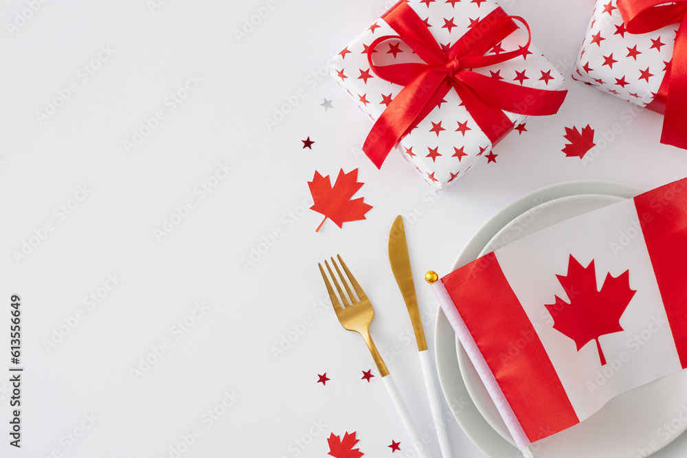 Canada Day-themed table setup. Top view flat lay of plate, cutlery ...