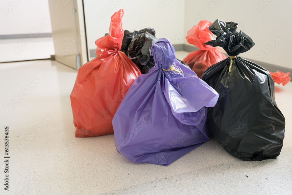 Different waste bag on white floor background,Red, black and purple ...