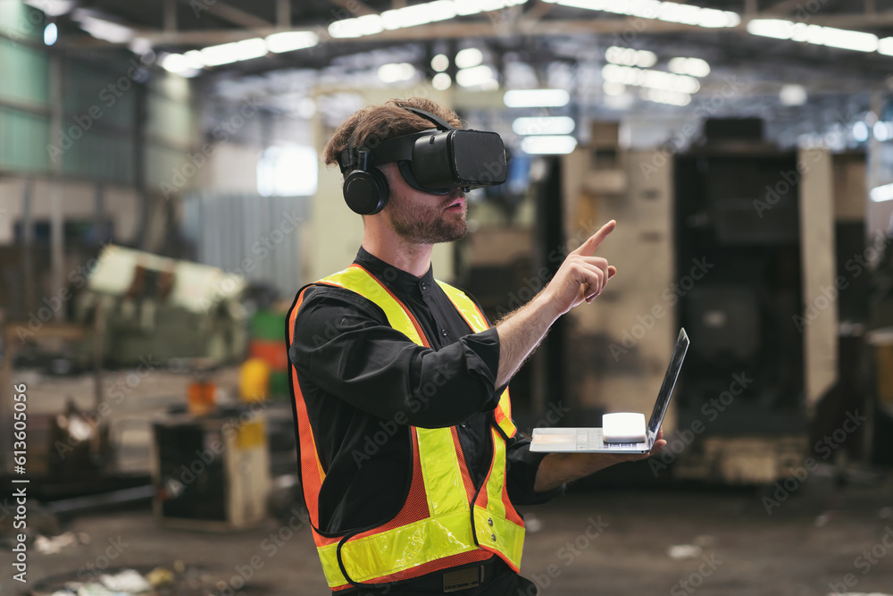 Male factory mechanic using virtual reality headset. Male engineer working or using virtual ...