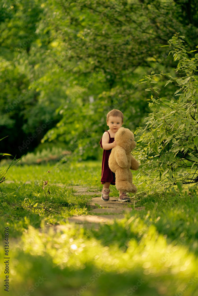 sunny park day with a toddler girl and her best friend, a giant teddy ...
