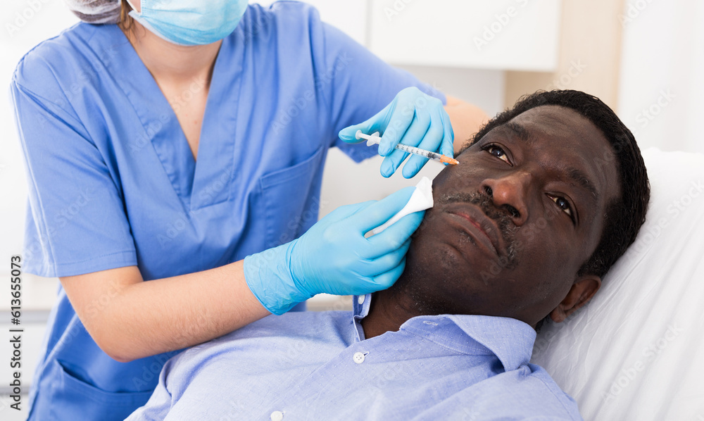 Afro american man getting procedure of injection for face skin ...