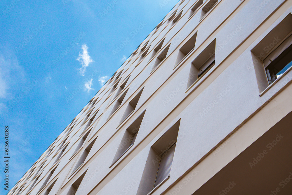 A beige facade of a modern multistory residential building, house view ...