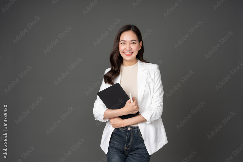Asian female executive with long hair cute smile holding tablet and pen ...
