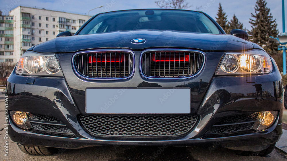 Front bumper with luminous headlights and parking lights of a dark BMW ...