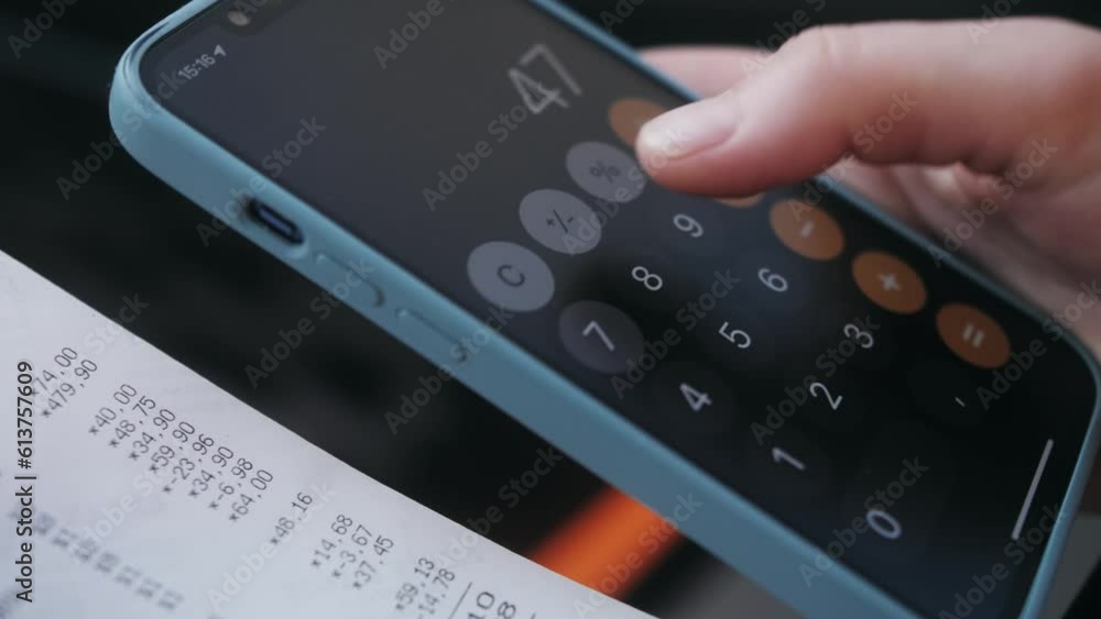 Woman use phone application to calculate bill after shopping at the ...