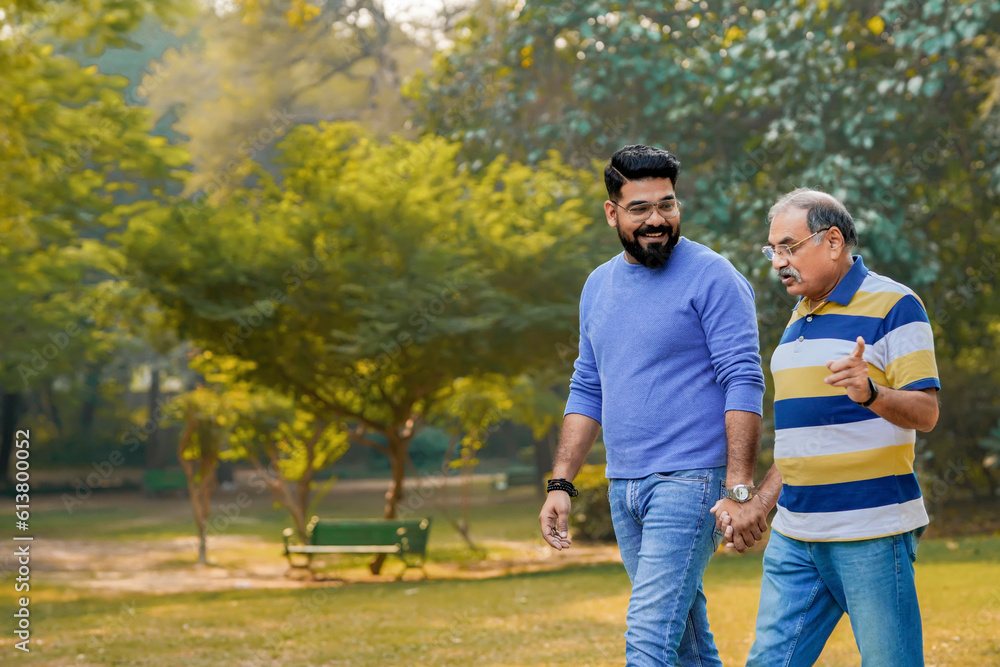 Old indian father with his young son spending time at park. Stock Photo ...