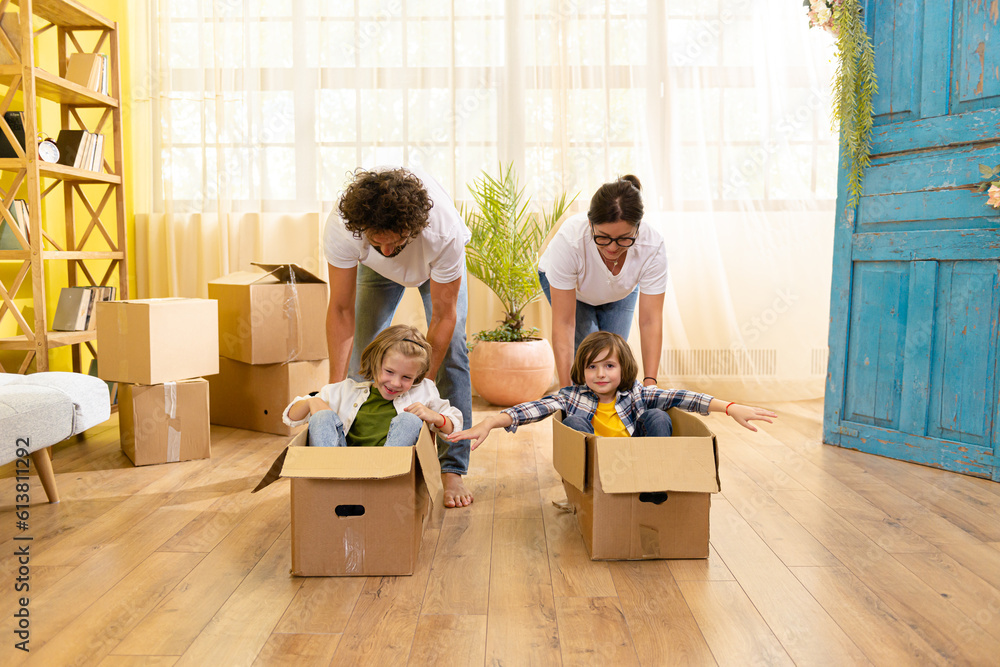 In the new home in living room excited family open the boxes dad with ...