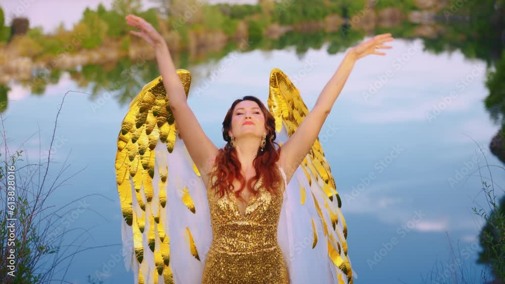 Fantasy happy woman archangel folds hands in prayer raised to blue sky ...