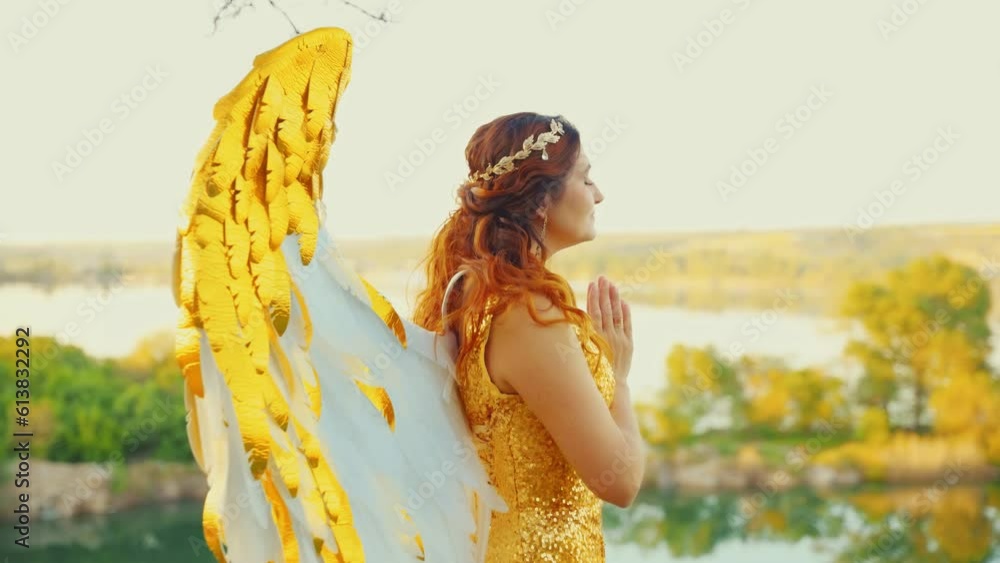 Fantasy happy woman archangel folds hands in prayer raised to blue sky ...