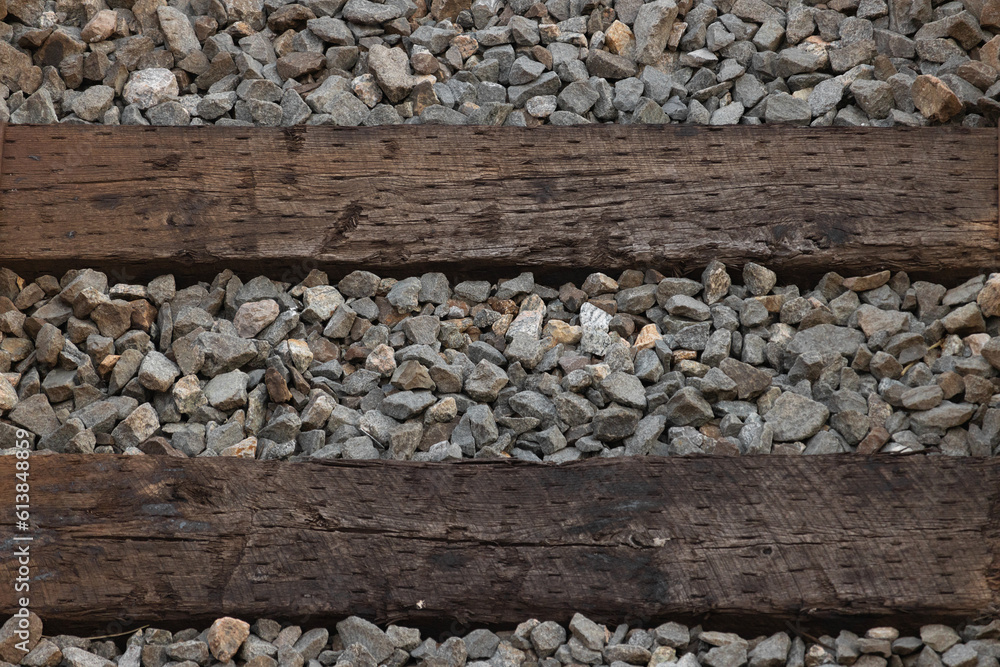 close up detail of weathered wood slats layered with gravel stones make ...