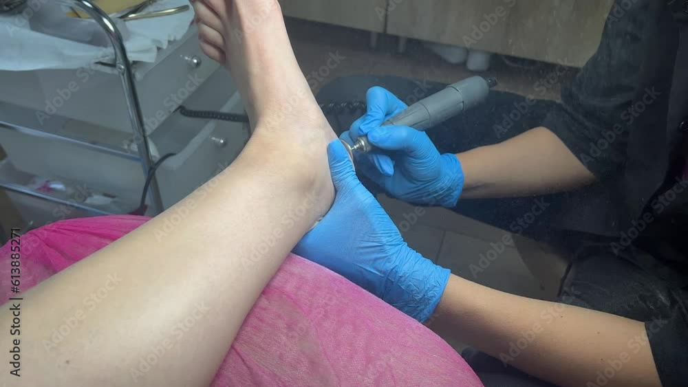 Hardware pedicure, foot treatment. Professional hardware pedicure using ...