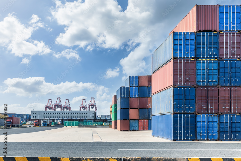 Stacked containers and pavement and buildings at port Stock Photo ...