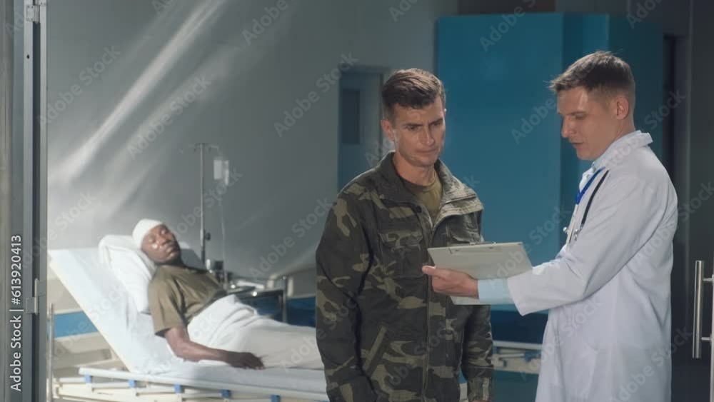 Soldier in uniform shaking hands and thanking doctor, talking about ...