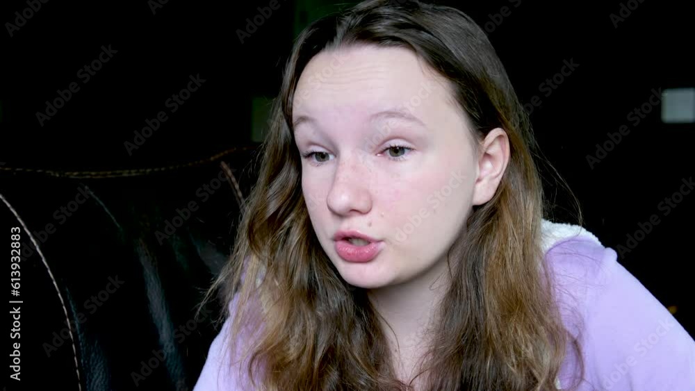 teenage sits on floor watches netflix on big screen of TV screensaver ...