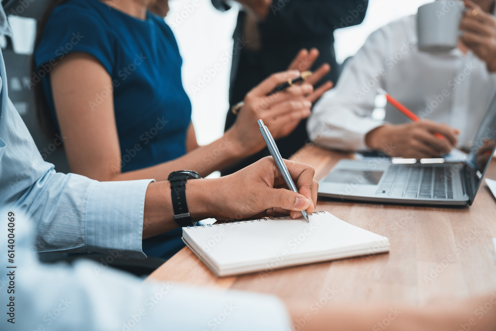 Secretary taking notes on notebook at corporate meeting with group of ...