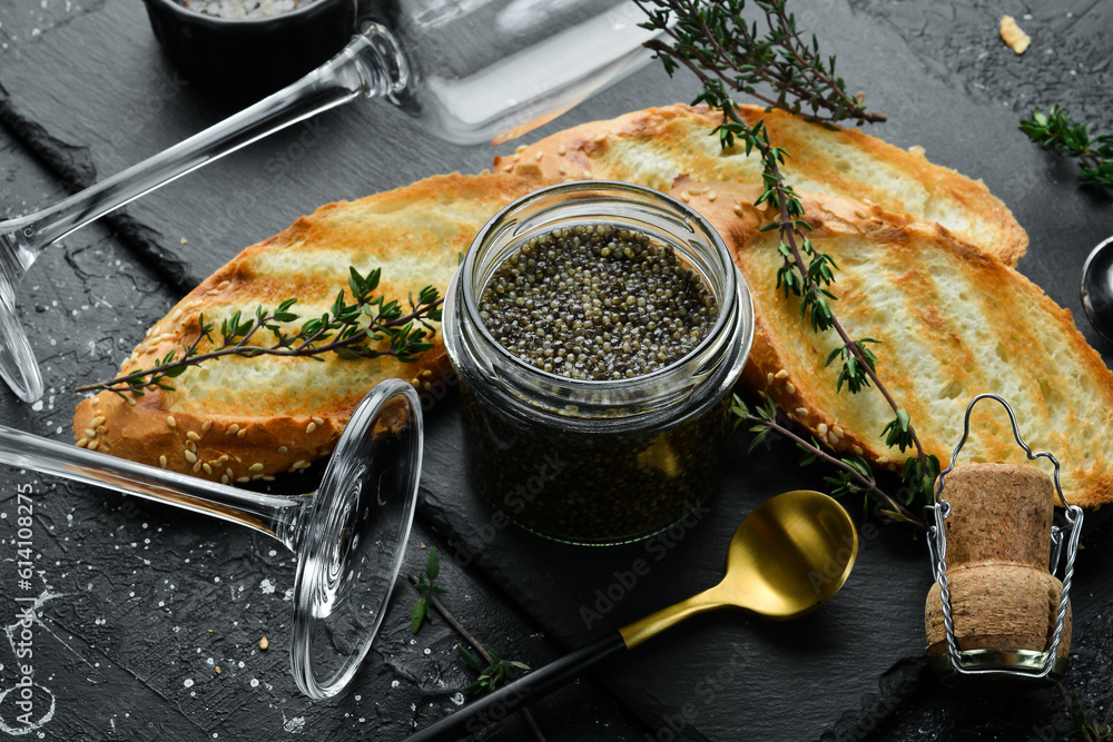 Beluga black caviar and toast bread. Preparation of luxury snacks. On a ...