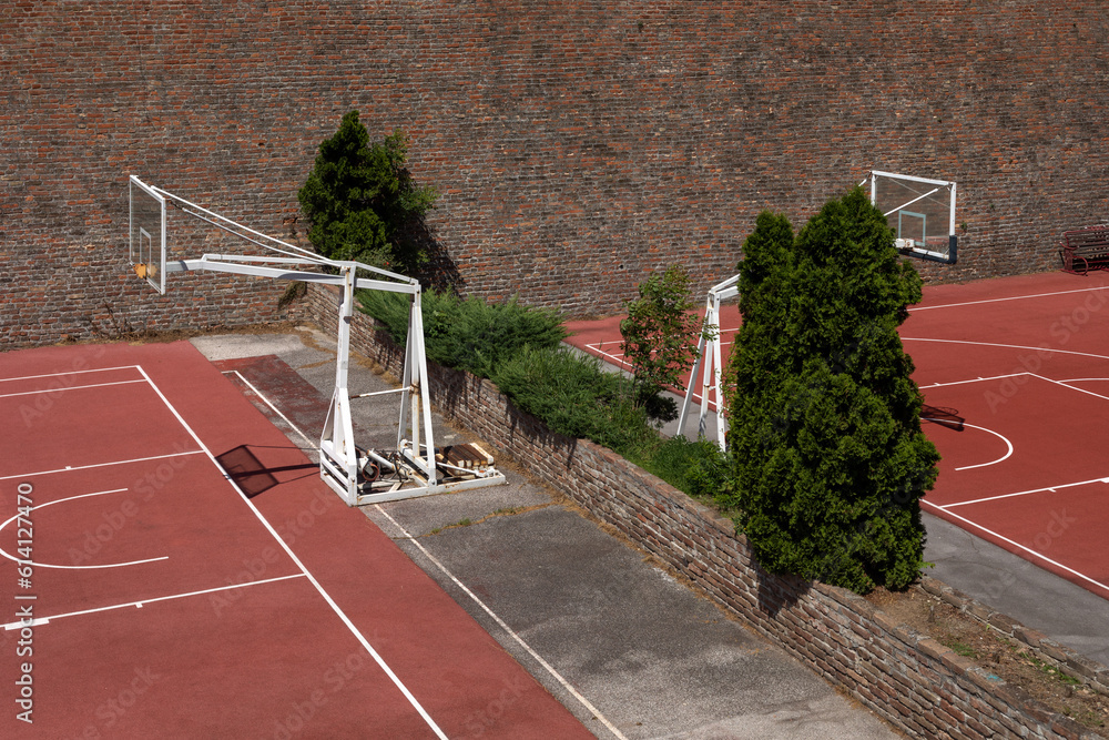 Basketball playground in front of the high-rise brick wall. Stock Photo ...