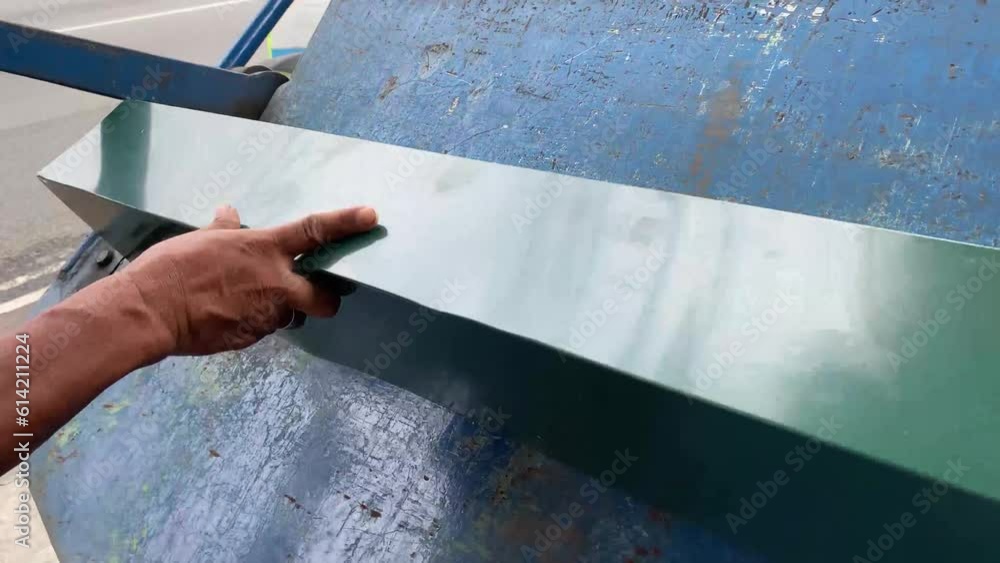 The manual process of bending long metal parts made of thin galvanized ...