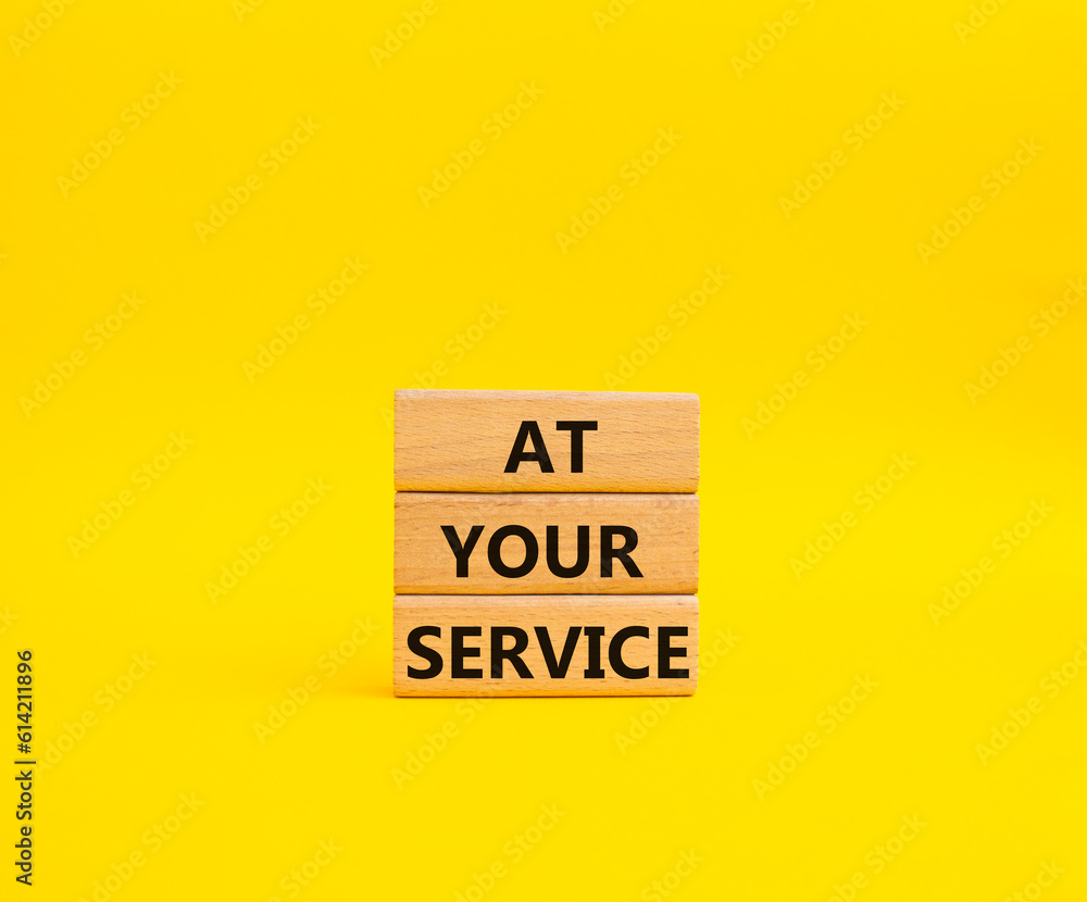 At your service symbol. Wooden blocks with words At your service ...