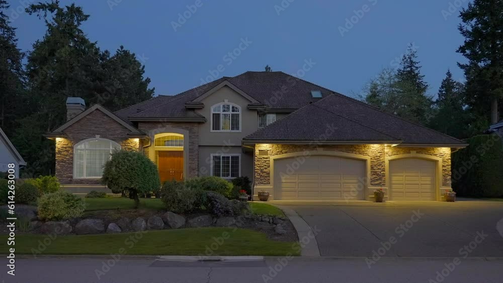 Establishing shot of two story stucco luxury house with garage door ...