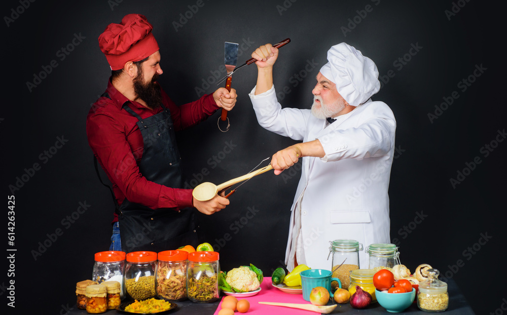 Two chefs fighting with kitchen utensils. Professional culinary. Chefs ...