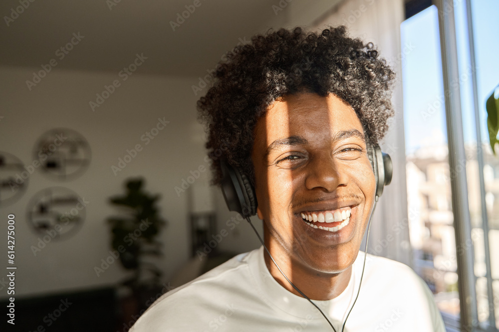 Happy funky gen z hipster African American guy wearing headphones ...