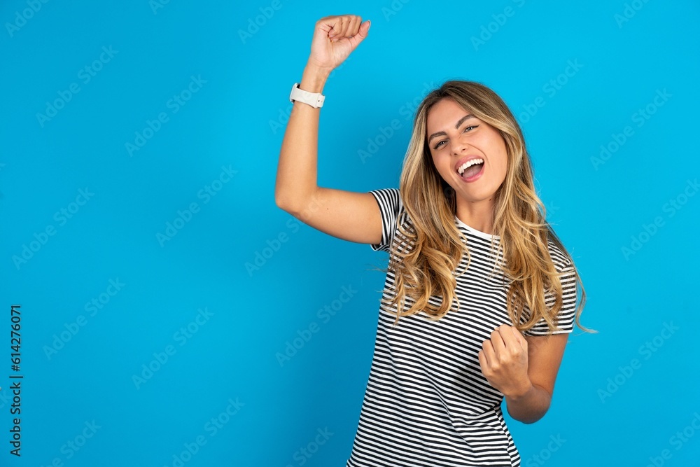 Profile photo of excited Young beautiful blonde woman wearing striped t ...
