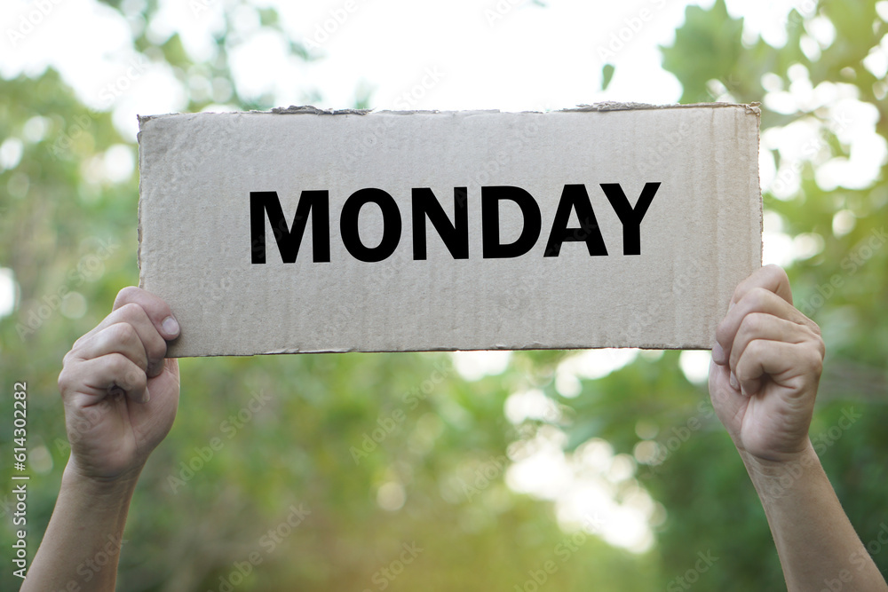 Hands hold word card for teaching with word MONDAY. Concept, language ...