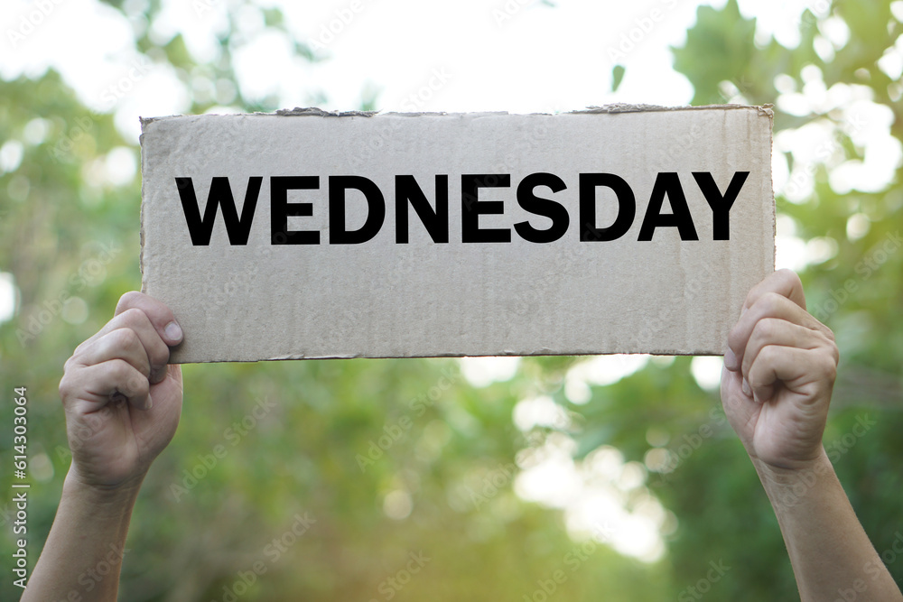 Hands hold word card for teaching with word WEDNESDAY. Concept ...