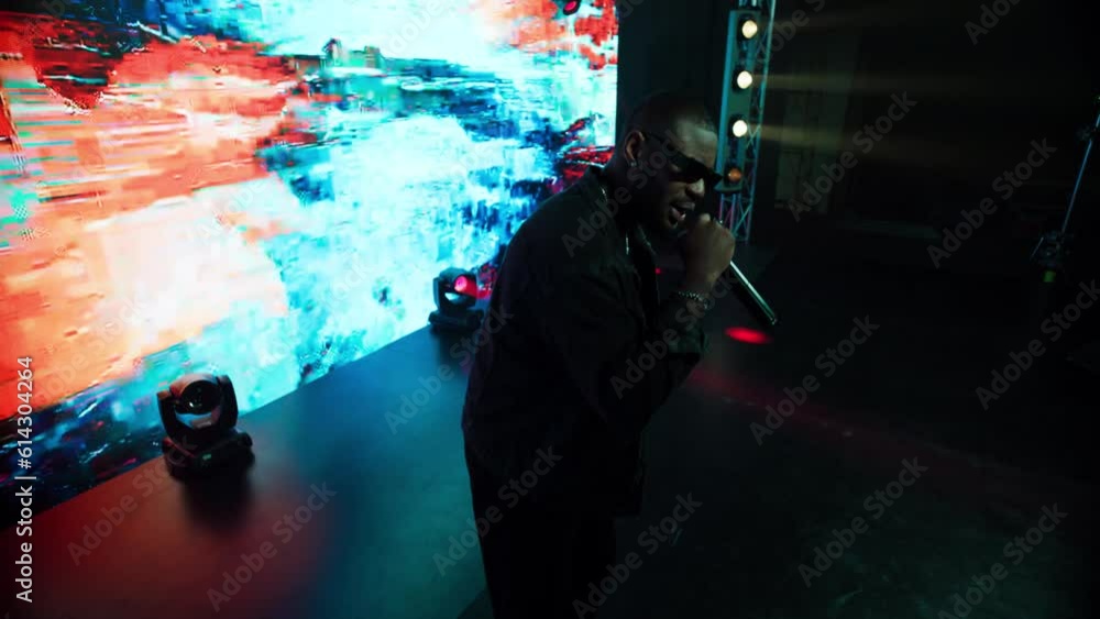 African-American Black rap artist performing his gig on a stage of a ...