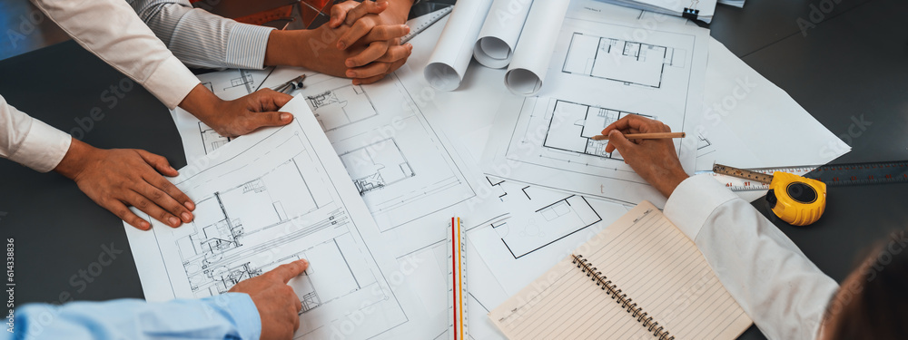 Engineer partner drawing and working on blueprint design together on ...