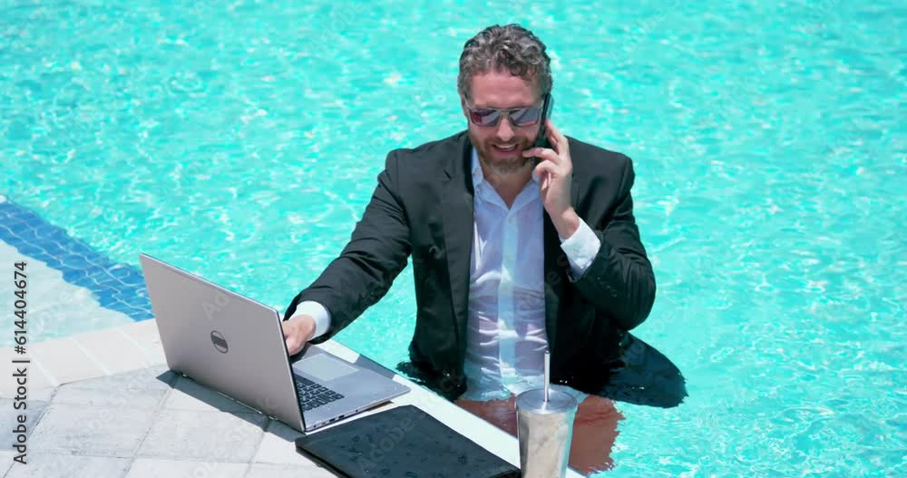 Businessman in suit with laptop in swimming pool. Crazy business man on ...
