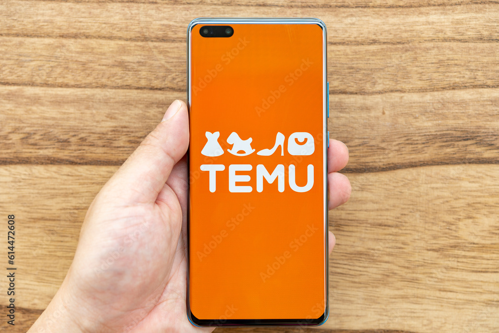 ZHONGSHAN China-June 15,2023:man holding a mobile with Temu logo at ...