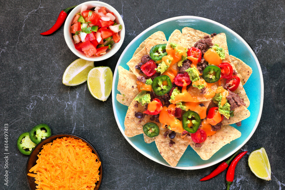 Fully loaded nachos with beef and cheese. Mexican food dish. Top down ...