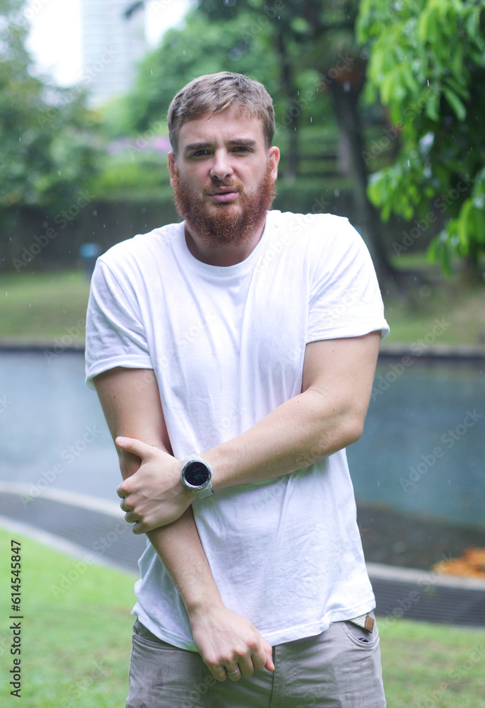 Sad frozen man under summer rain.emotional wet in the rain without ...