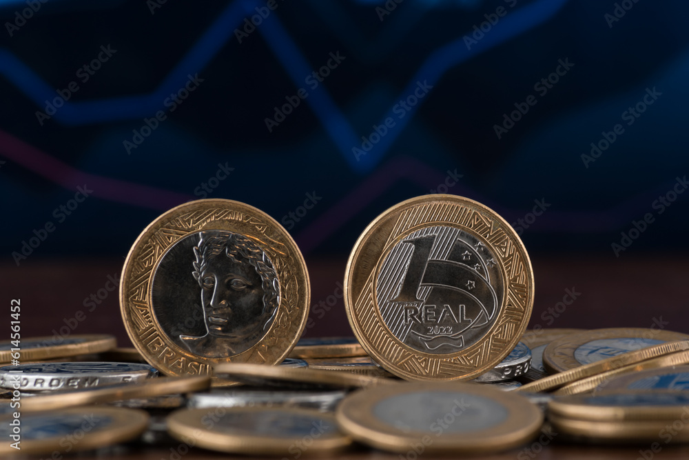 two brazilian 1 real coins heads and tails in a pile of brazilian coins ...