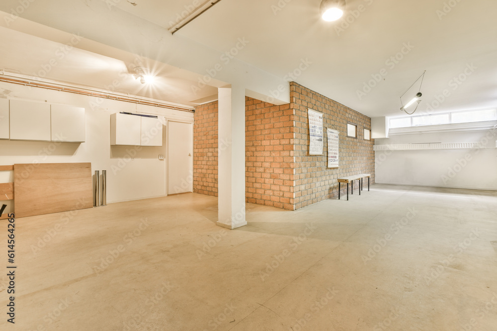 an empty room with brick walls and white cupboards on the wall, there ...