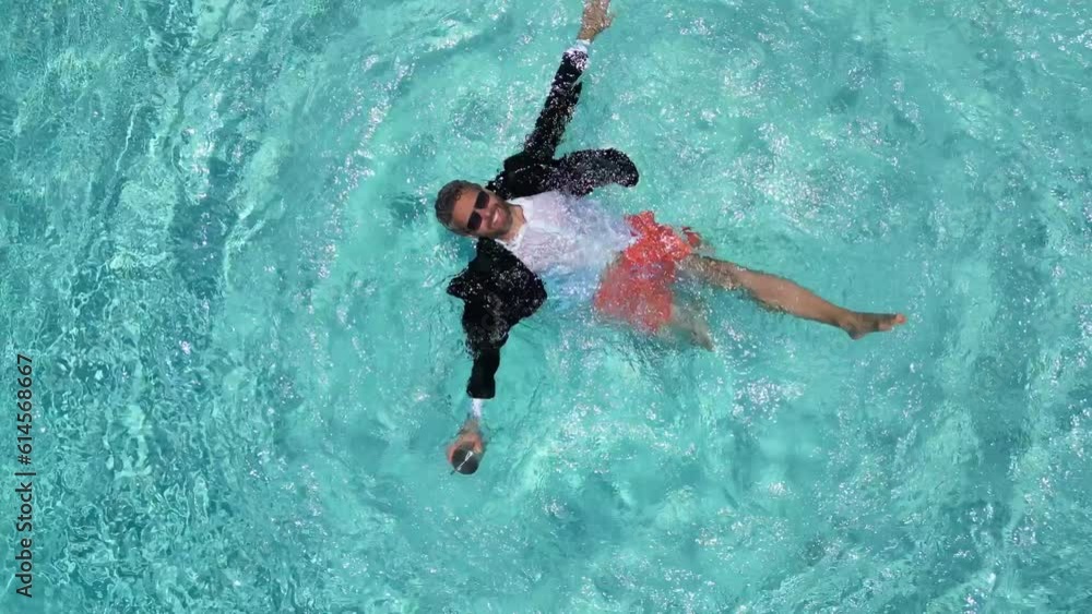 Excited businessman in wet suit swim in sea pool water. Funny ...