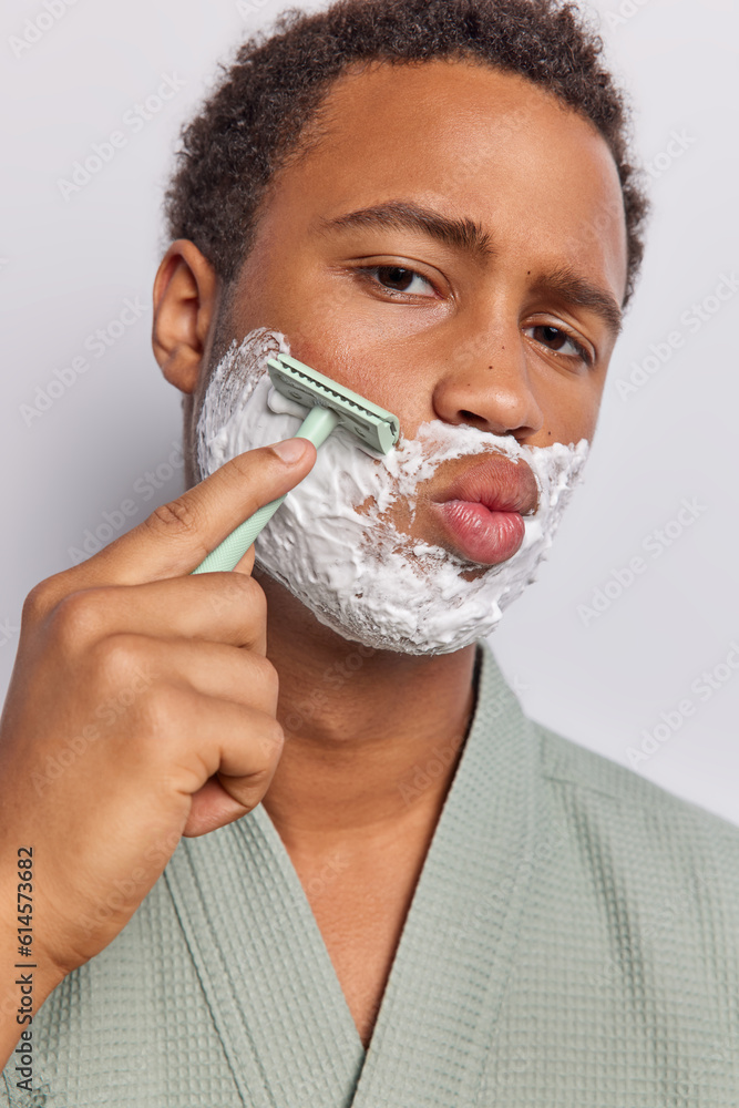 Vertical image of serious man with determined expression meticulously ...